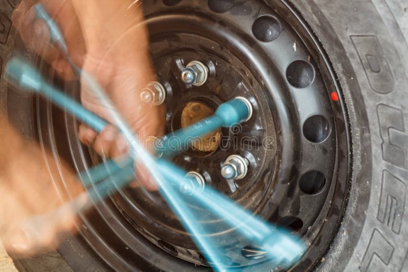Moving of Changing Tire with Wheel Wrench. Stock Image - Image of ...