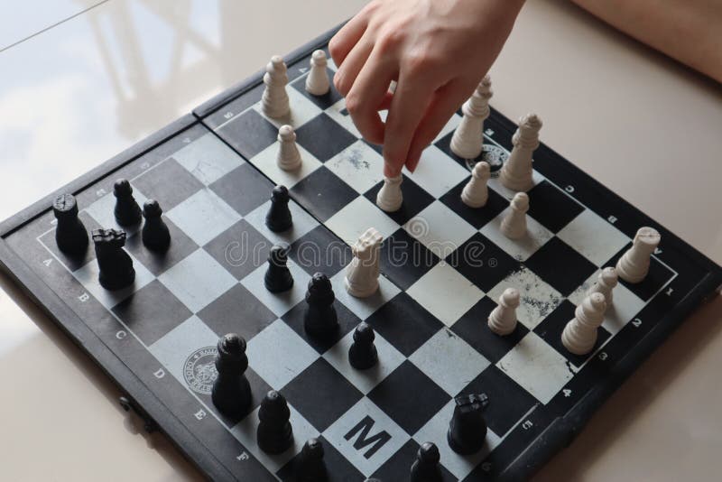 Moving a Chess Piece while Playing a Chess Game at Home Stock Image ...
