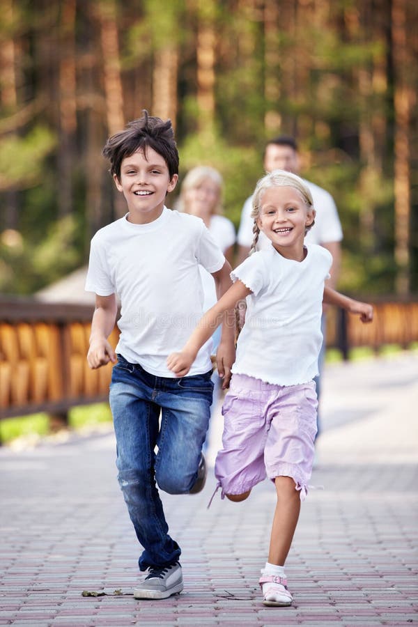 Two Young Children Running on Path Smiling Stock Image - Image of ...