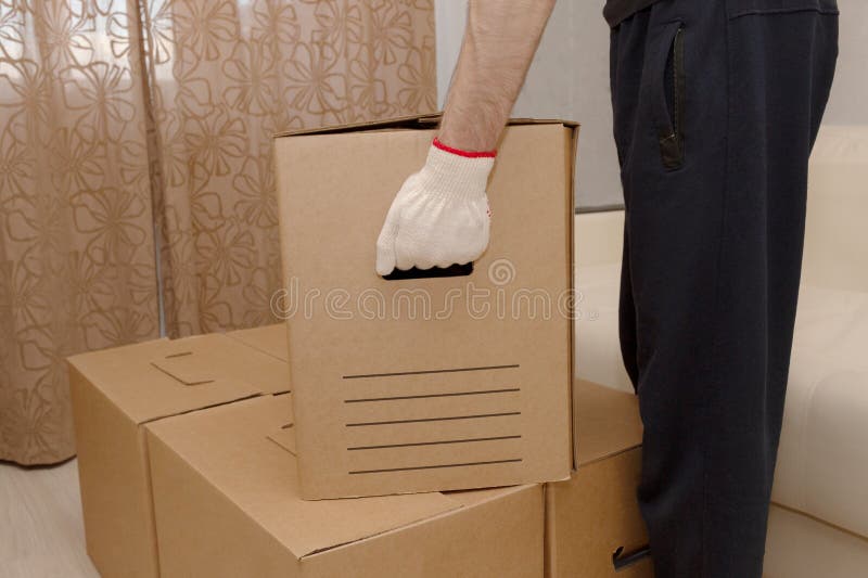 Moving. the Man Takes the Box from the Apartment To Move it. Stack of ...