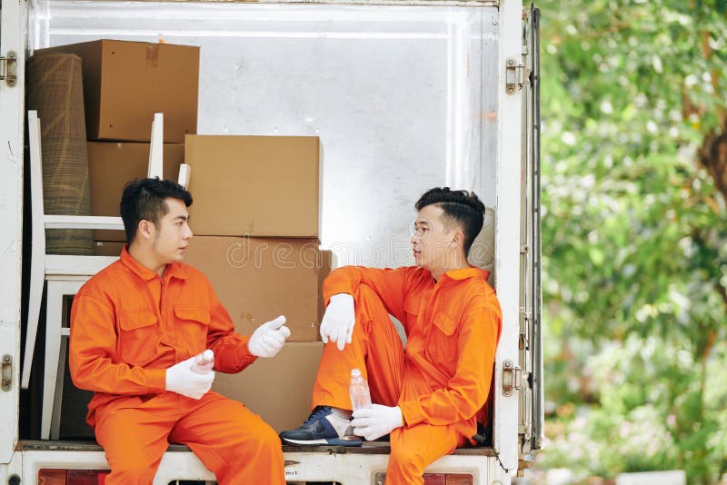 Moving Men Having Rest stock photo. Image of delivering - 187199744