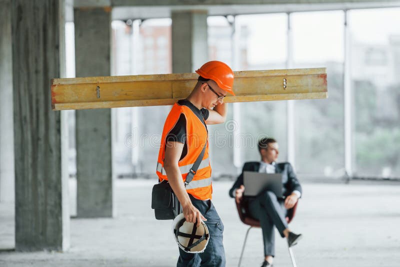 Moving Object. Man in Suit and Handyman in Orange Protective Wear is ...