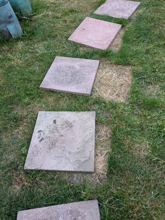 Moving Patio Tiles on Grass and Leaving Marks Stock Photo - Image of ...