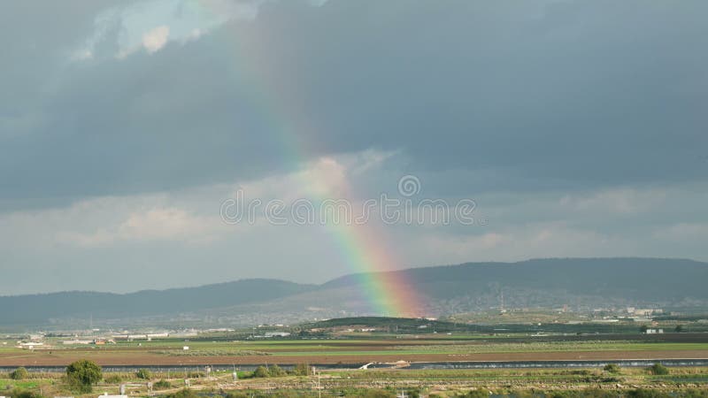 Moving Rainbow Over the Fields of Galilee, Israel with Sun Rays Stock ...