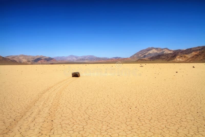 Moving Rock On Cracked Desert Ground Royalty Free Stock Photo - Image ...