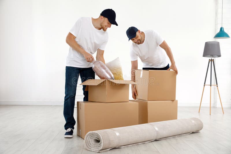 Moving service employees stock photo. Image of cardboard - 151515540