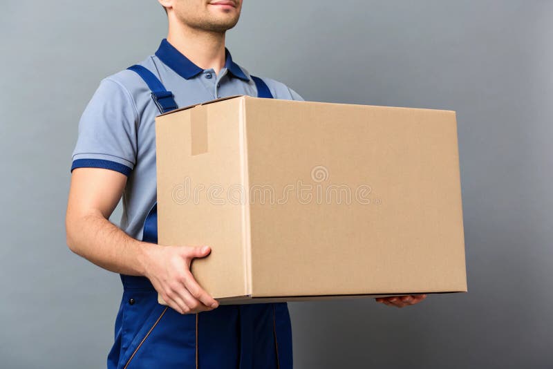 Moving Service Worker Holds Cardboard Box Close-up. Mover in Uniform ...
