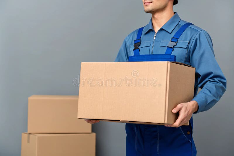 Moving Service Worker Holds Cardboard Box Close-up. Mover in Uniform ...