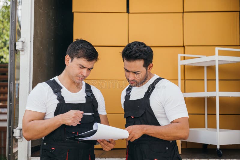 Teamwork Outdoors, Workers Unload Boxes Checking Documents for the ...