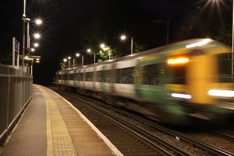 Moving Train Passing through Station at Night Stock Image - Image of ...