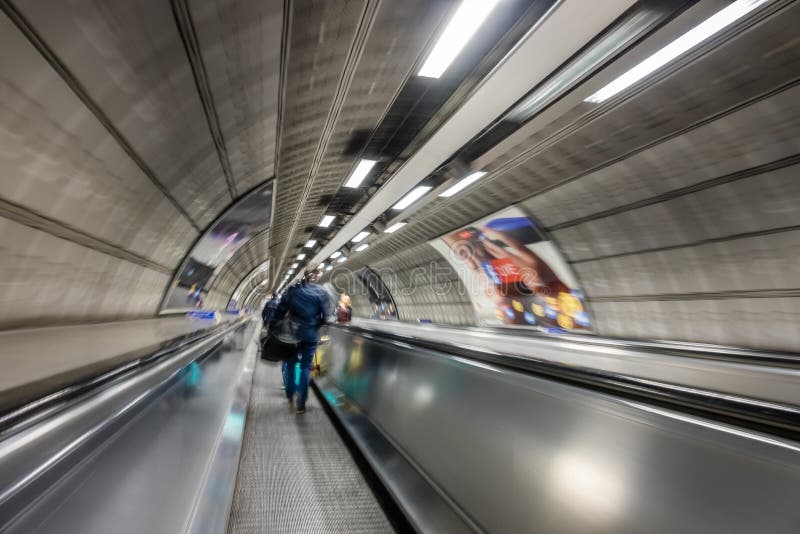 Moving walkway on tube editorial stock image. Image of person - 85023139