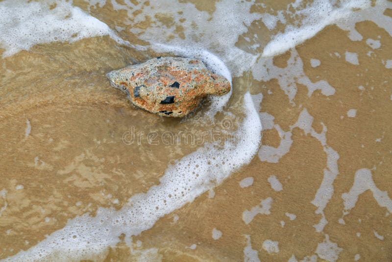 Moving wave on sand beach stock photo. Image of liquid - 103172500