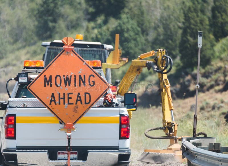 ``Mowing Ahead`` Sign on Back of Truck Stock Photo - Image of grass ...
