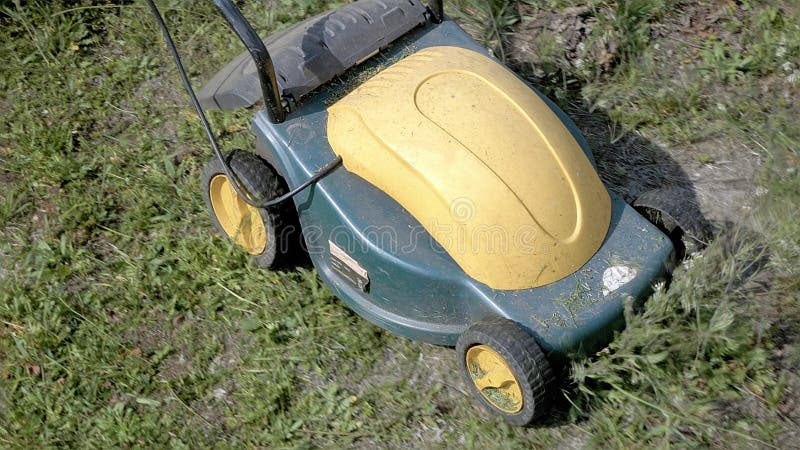 Mowing Grass in the Garden with Electrical Machine Stock Photo - Image ...