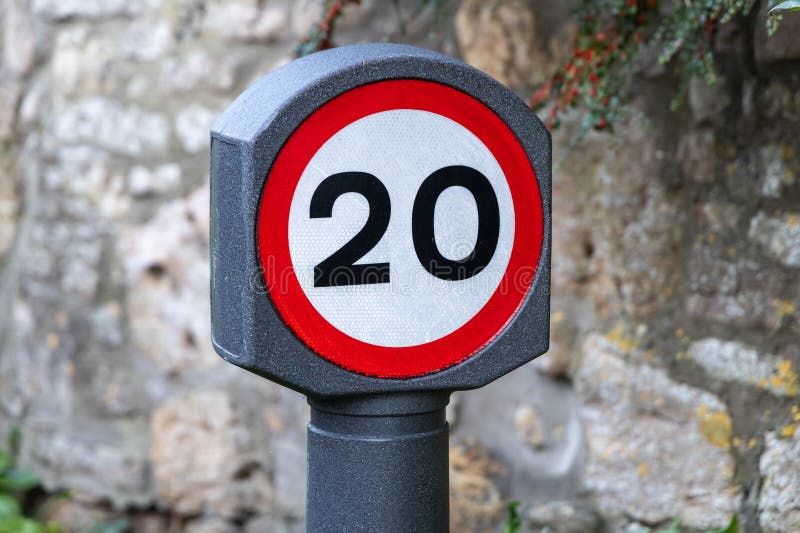 20 MPH Speed Limit Sign with Stone Wall and Plants in Background Stock ...