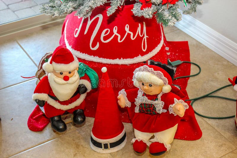 Small Mr. & Mrs. Santa Clause Sitting in Front of Christmas Tree Stock ...