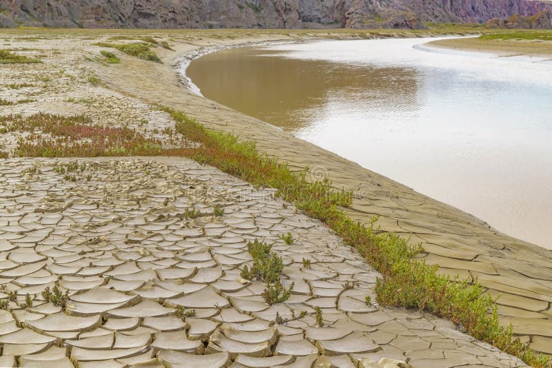 Mud Cracked Soil and River stock image. Image of shore - 89578507