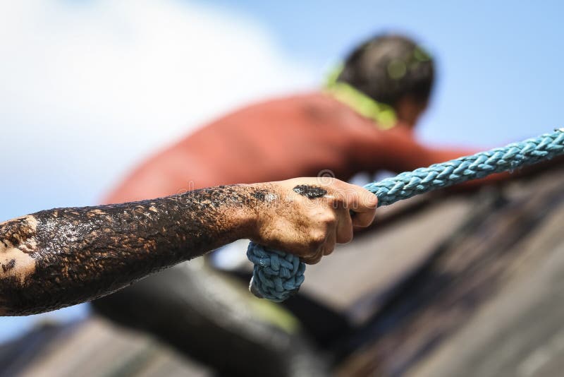 Mud Race Runners,defeating Obstacles by Using Rope Stock Image - Image ...