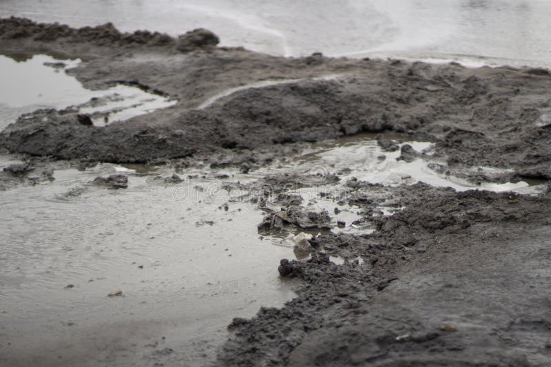 Mud and Snow. Melted Snow Formed a Muddy Puddle Stock Photo - Image of ...