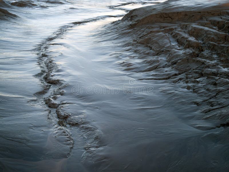 Water drenched mud flats stock image. Image of abstract - 143534983