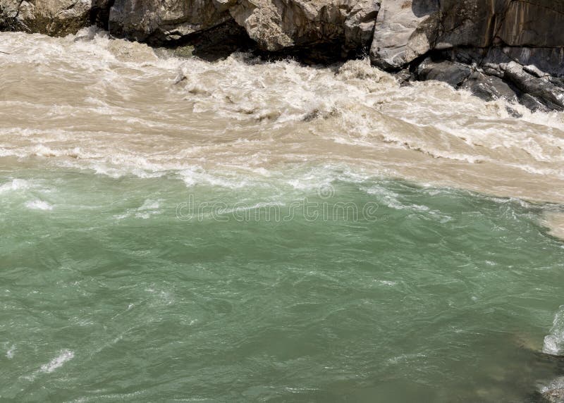 Muddy Flood Water and Pure Clear Water Flowing Parallel with Each Other ...