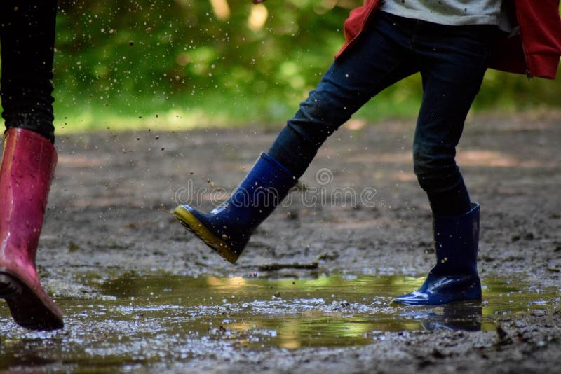 Children Splashing and Playing in a Muddy Puddle Stock Image - Image of ...