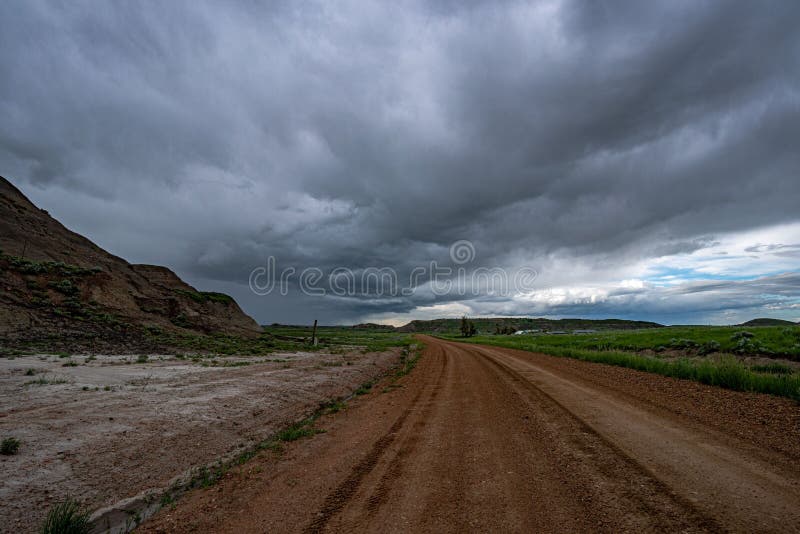 Muddy Road with a Dark Clouds Above Stock Photo - Image of road, storm ...