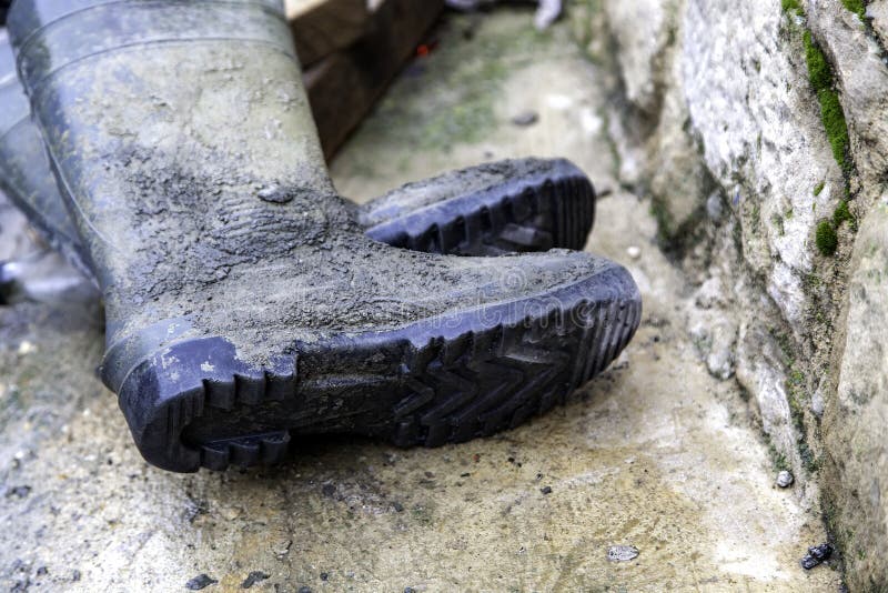 Worker in Rubber Boots Stands in Uncluttered Cement and Leveling the ...