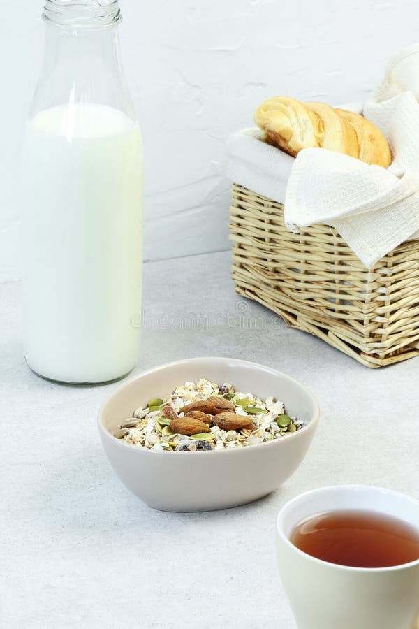 Muesli Breakfast with Milk, Tea and Croissant on Grey Table Stock Photo ...