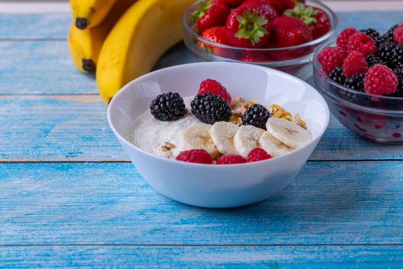 Muesli with Yogurt and Fruit on Wooden Table. Stock Photo - Image of ...