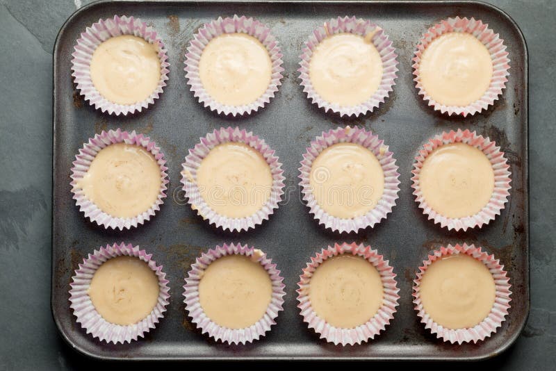 Muffin Cups with Cake Batter in Baking Tray Stock Photo - Image of ...
