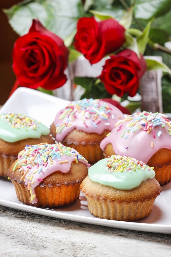 Muffins Covered With Pink Icing And Colorful Sprinkles Stock Photo ...