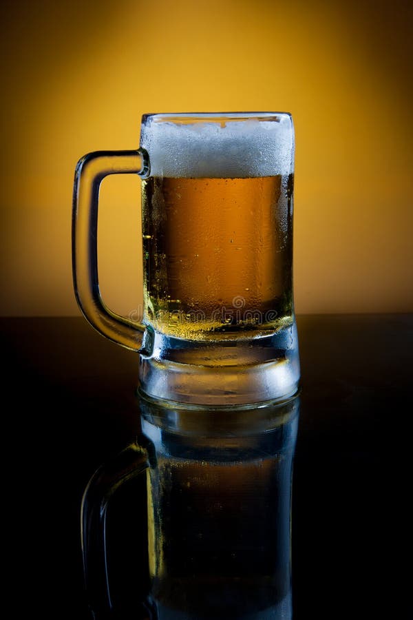 Mug of Beer with Reflection on Table Stock Photo - Image of foam ...