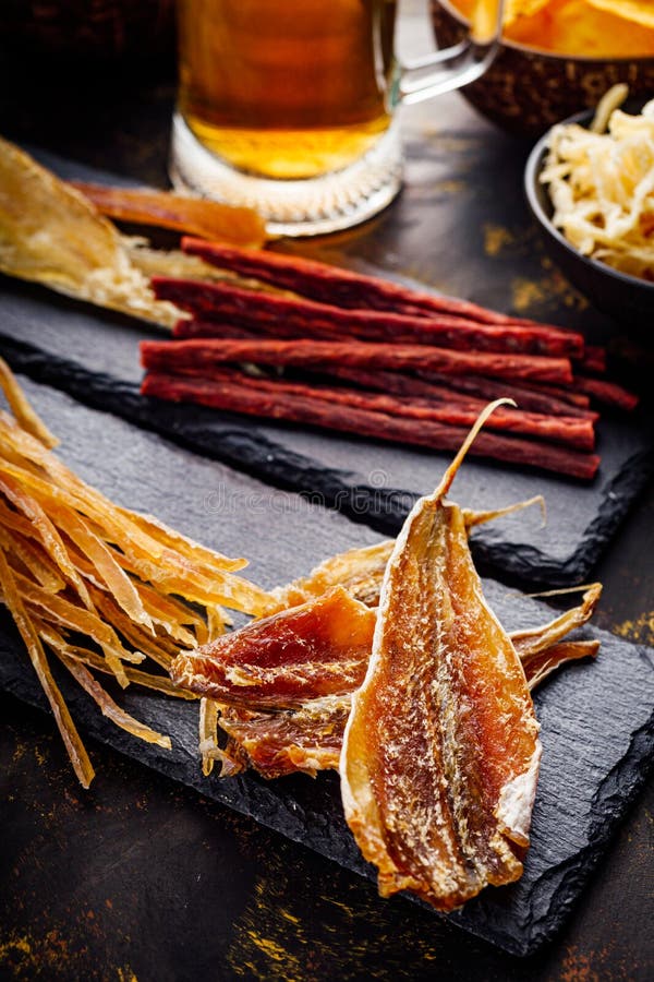 Mug of Beer and a Set of Dry Fish Snacks on a Dark Background Stock ...