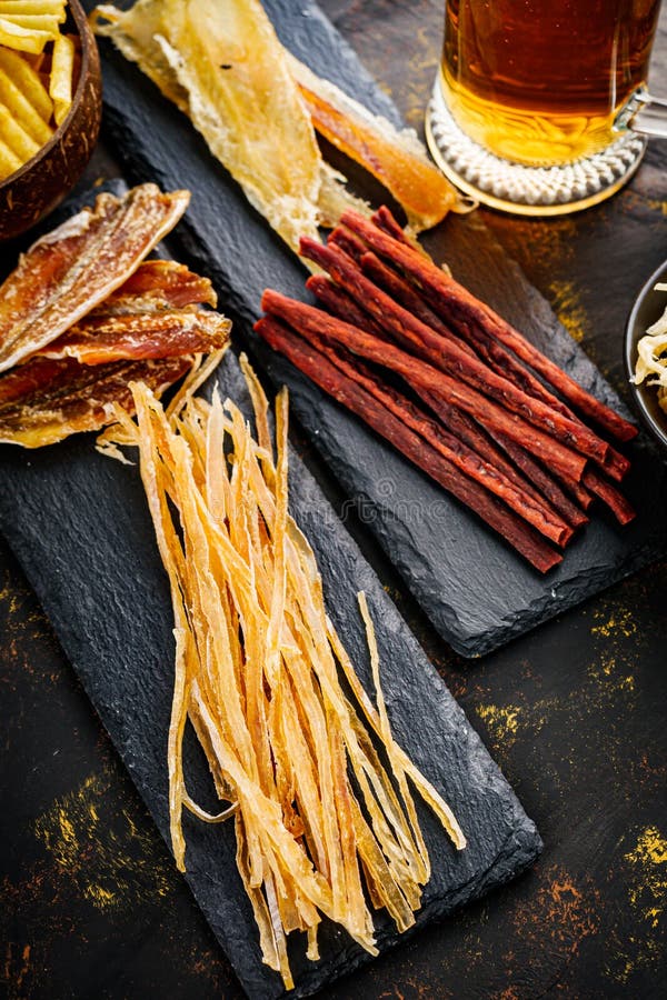 Mug of Beer and a Set of Dry Fish Snacks on a Dark Background Stock ...