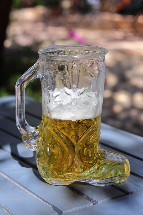 A Mug of Beer in the Shape of a Boot. Stock Photo - Image of yellow ...