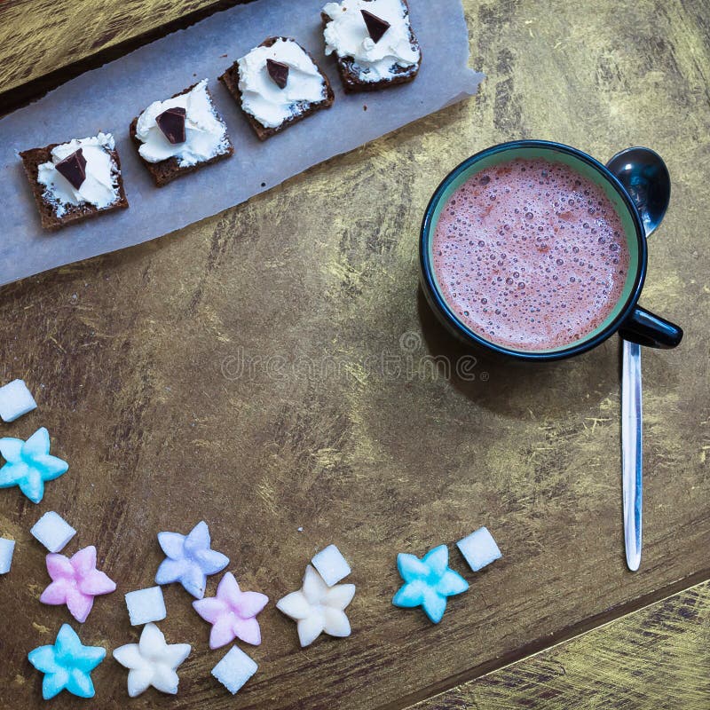 Mug of cocoa and sweets stock photo. Image of cubes - 145824590