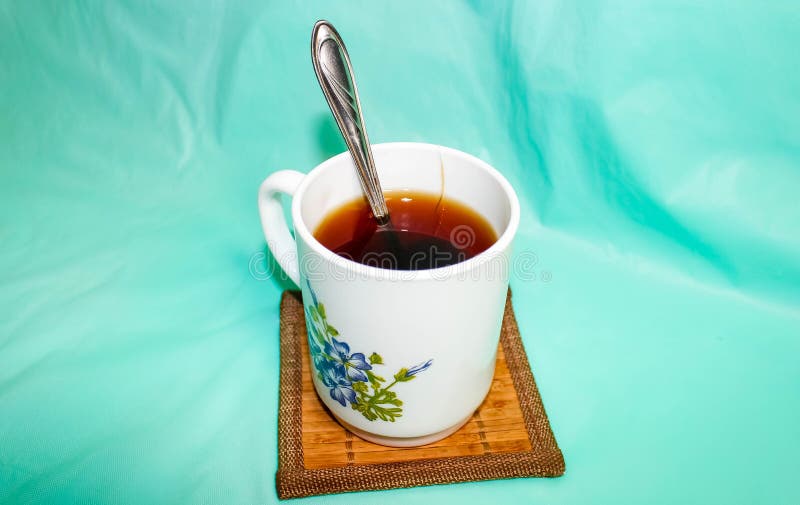 A Mug with Hot Tea and a Teaspoon Stands on the Coaster Stock Image ...