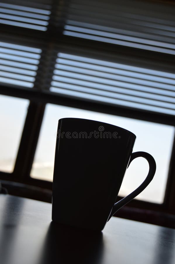 Moody Composition of Silhouetted Mug Framed within a Window Stock Photo ...