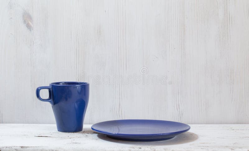 Mug and plates on table stock image. Image of wooden - 187125945