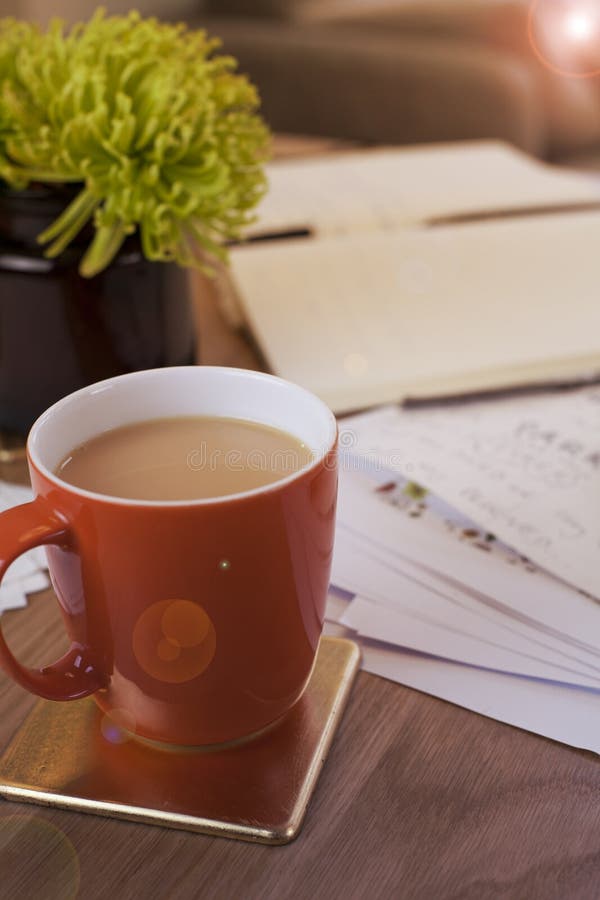 Mug of Tea or Coffee on Work Surface with Notebooks and Papers and a ...