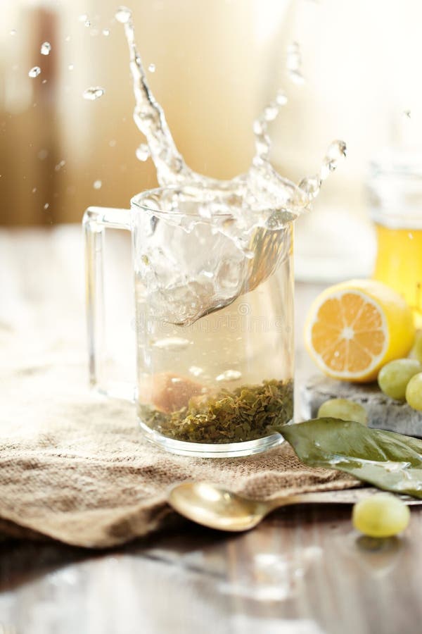 A Mug of Tea with Large Splashes, Lemon, Grapes on the Table. Morning ...