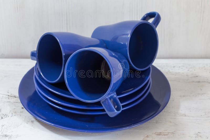 Mugs and plates on table stock photo. Image of white - 62887046