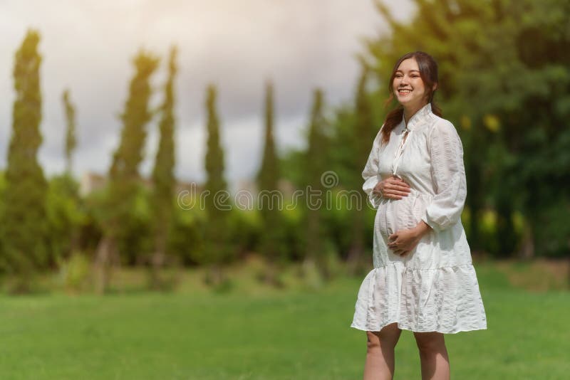 Mujer Embarazada Contenta Parada En El Parque Imagen de archivo ...