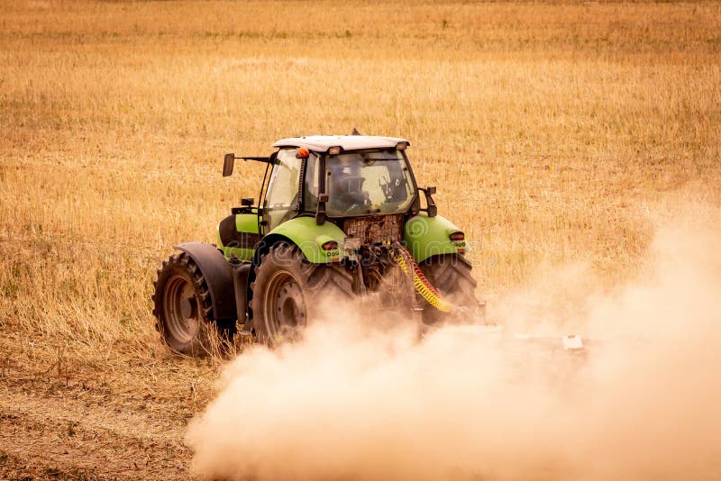 Mulching Tractor after Rapeseed Harvest among the Dust Stock Image ...