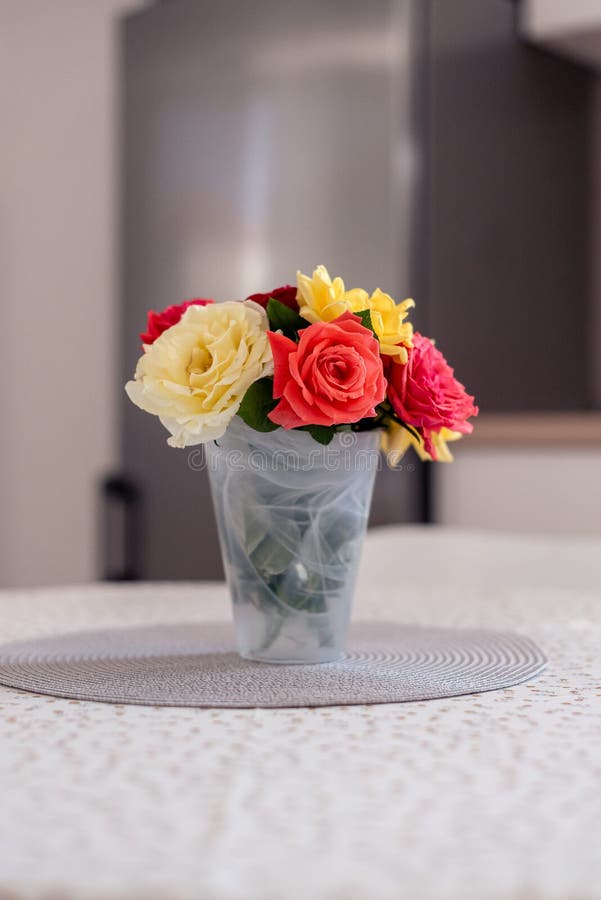 Multi-Colored Artificial Roses in Glass Vase on Decorative Table ...