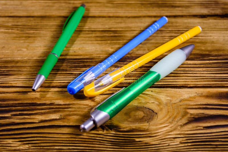 Multi Colored Ball Pens, Protractor and Ruler on a Wooden Table. Top ...