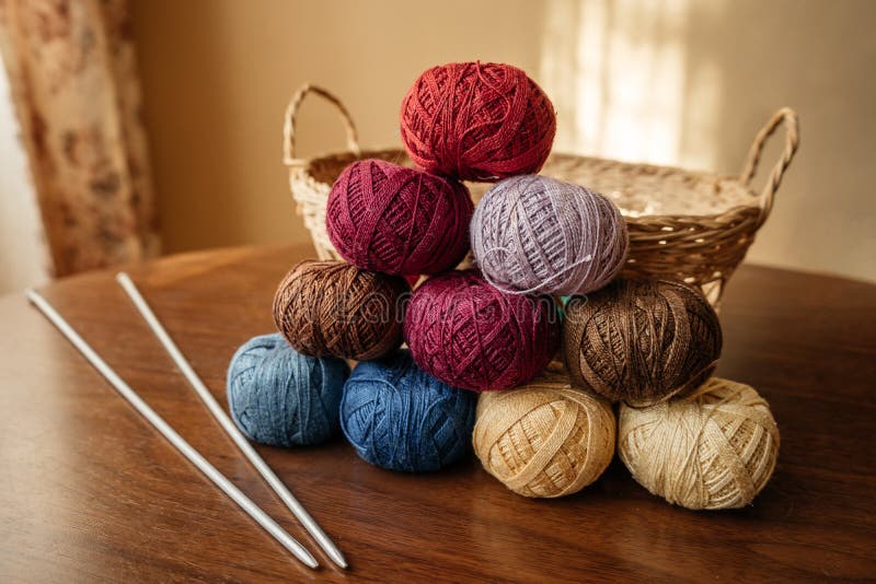 Multi-colored Balls of Wool Yarn Folded into a Pyramid on a Wooden ...