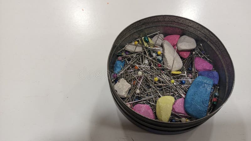 Multi-colored Pieces of Soap, Chalk and Needles are in a Tin Can in a ...
