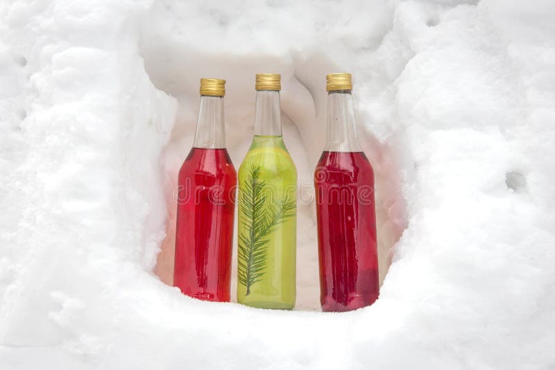 Bottles with Alcohol in the Snow.Multi-colored Bottles Stock Photo ...